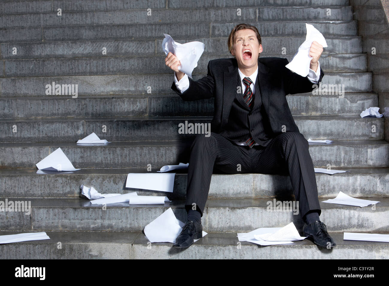 Image of grieving businessman crying with papers in hands Stock Photo ...