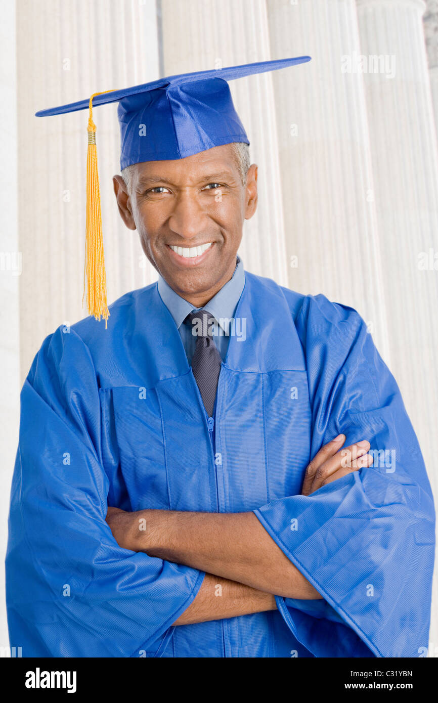 Mixed race man in graduation cap and gown Stock Photo - Alamy