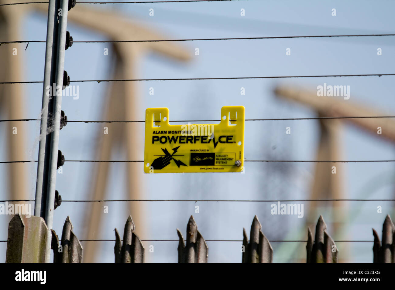Barbed wire and warning sign for electric fencing at electricity power ...