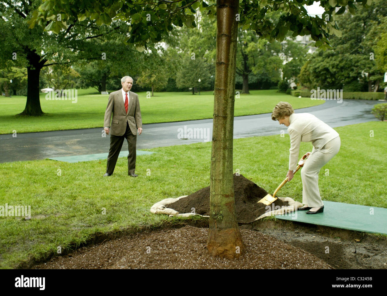 US President George W. Bush looks on as his wife, First Lady Laura Bush ...