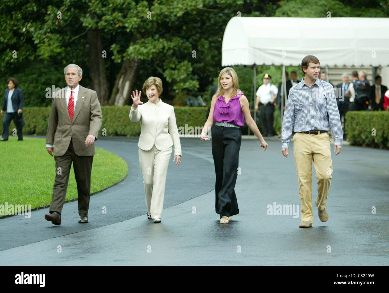 US President George W. Bush walks with his wife, First Lady Laura Bush ...