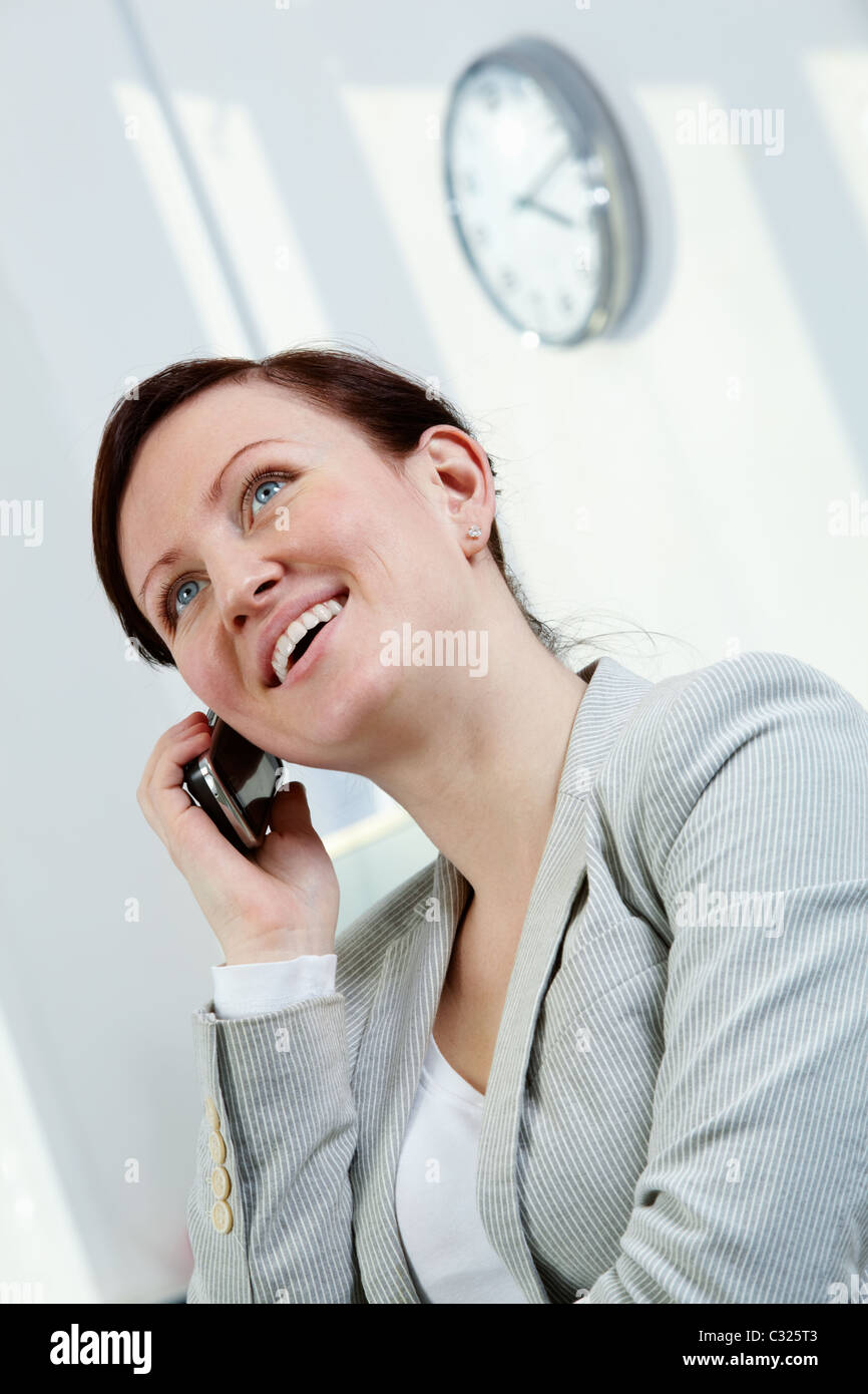Portrait of pretty businesswoman calling in office Stock Photo - Alamy