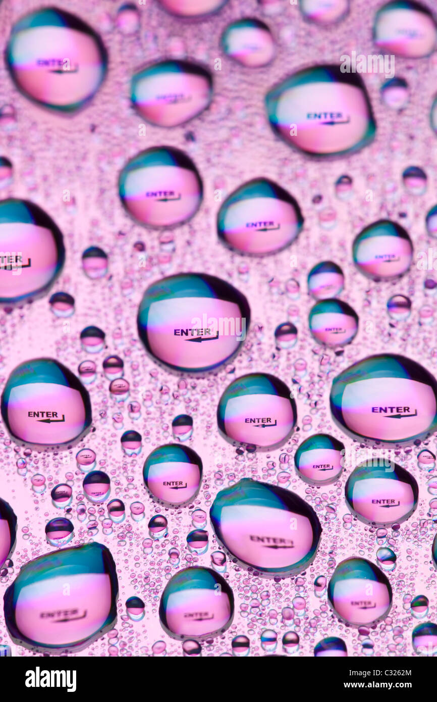 The words "Enter" reflected in the drops of water. Close-up of water ...