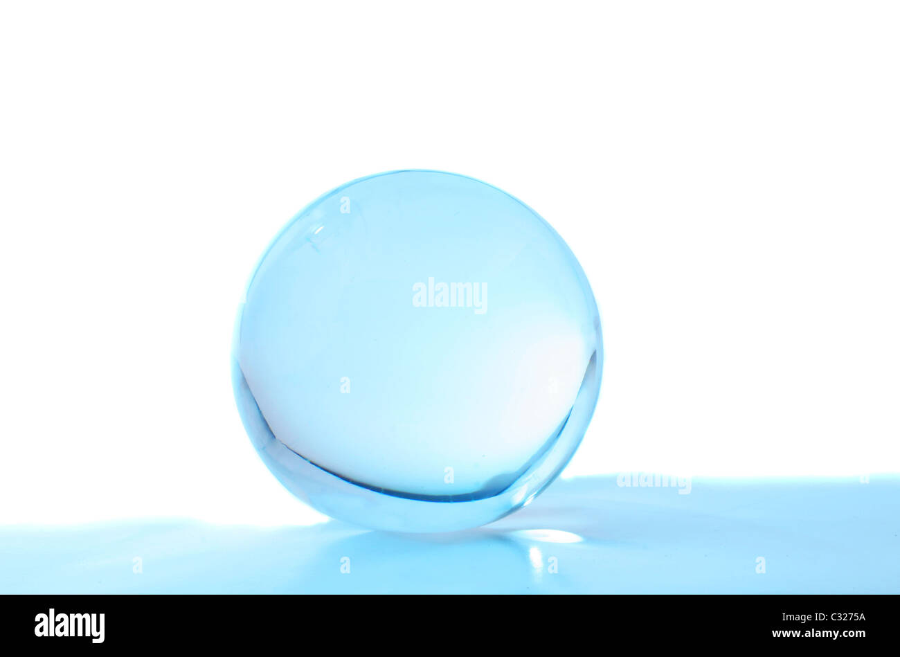 Crystal ball with turquoise light inside an foreground with a white ...
