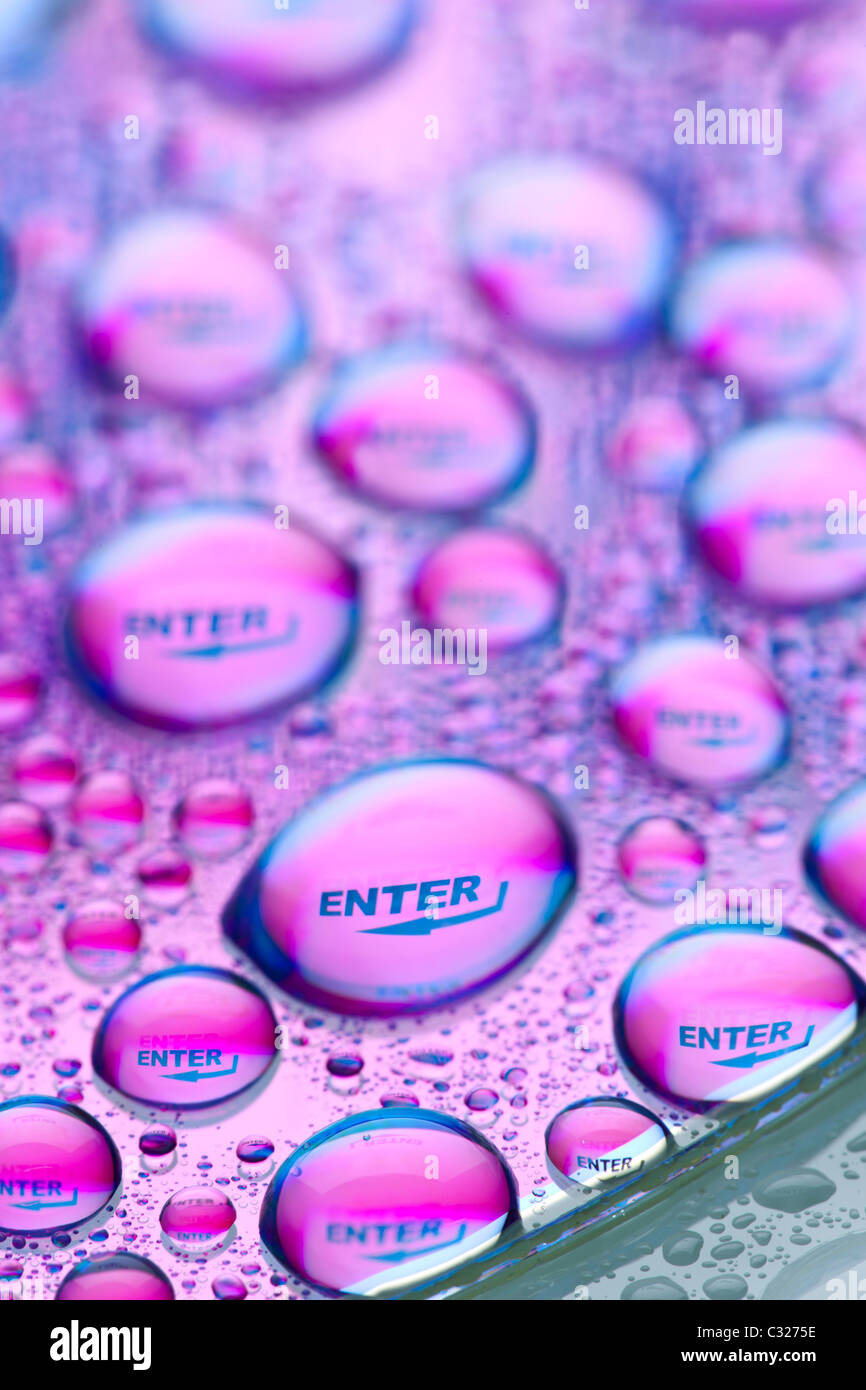 The words "Enter" reflected in the drops of water. Close-up of water ...