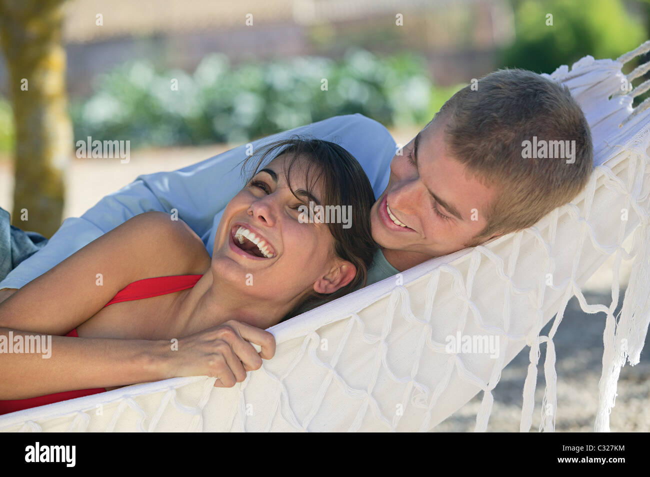Happy couple in a hammock Stock Photo - Alamy