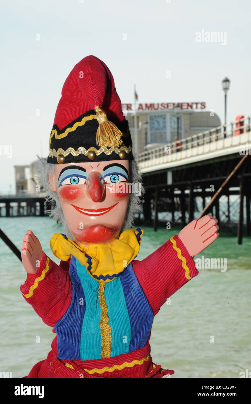 Mr Punch photographed with Worthing Pier behind Stock Photo - Alamy