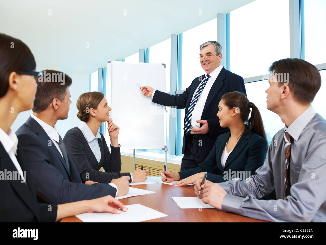Smiling man pointing during presentation hi-res stock photography and ...