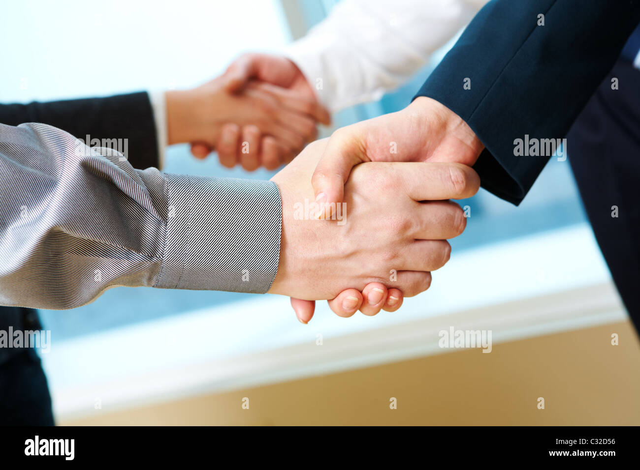Photo of two pairs of partners arms handshaking after striking deal ...