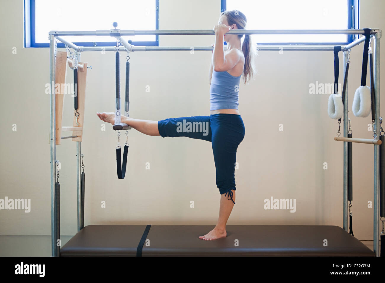 Young woman doing pilates Stock Photo - Alamy