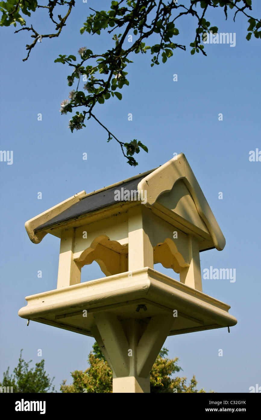 Nice bird table against a blue sky Stock Photo - Alamy