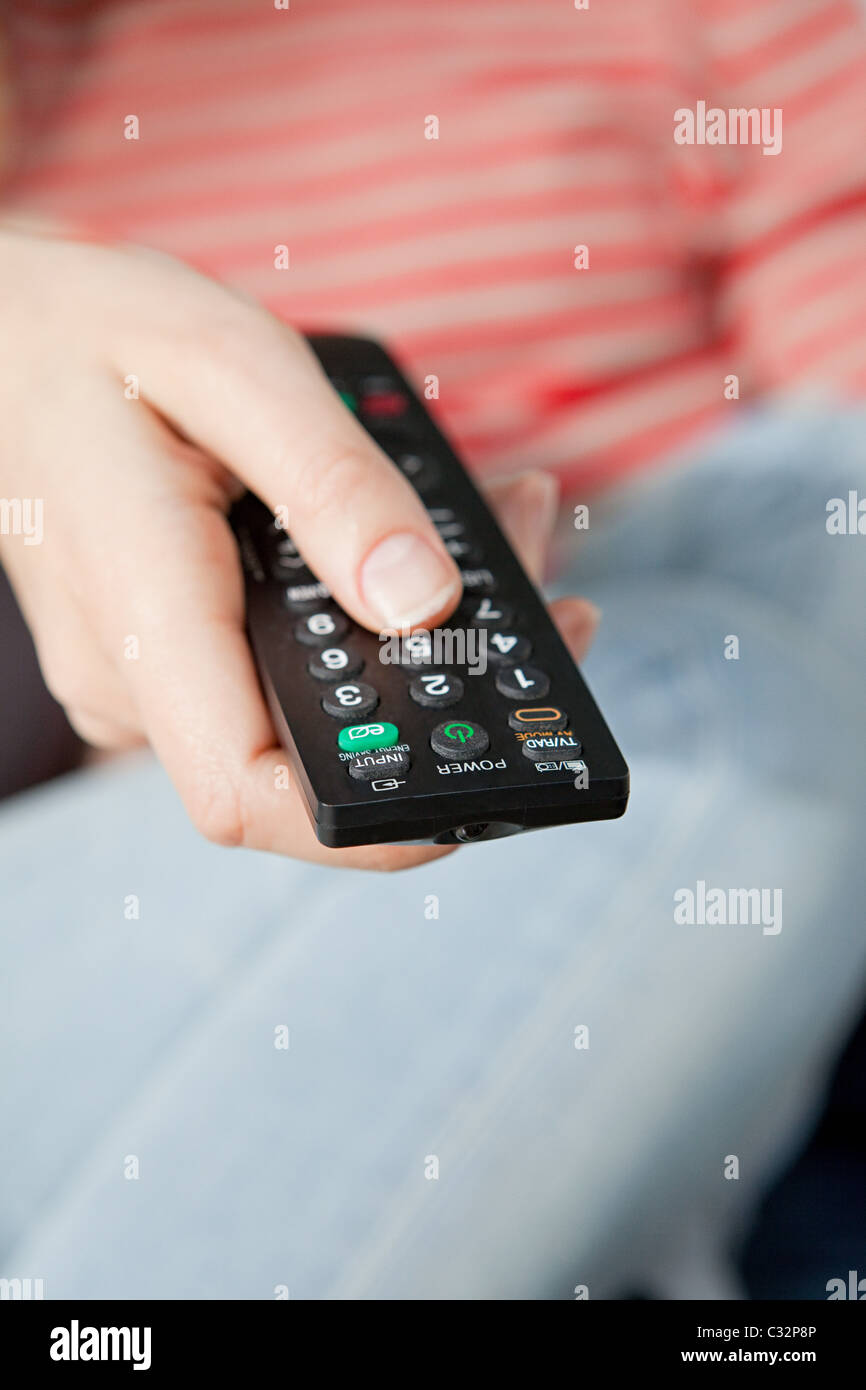 Young man with remote control Stock Photo - Alamy