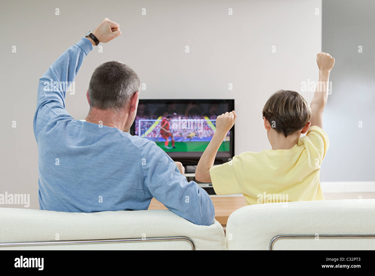 Older man watching football on tv hi-res stock photography and images ...
