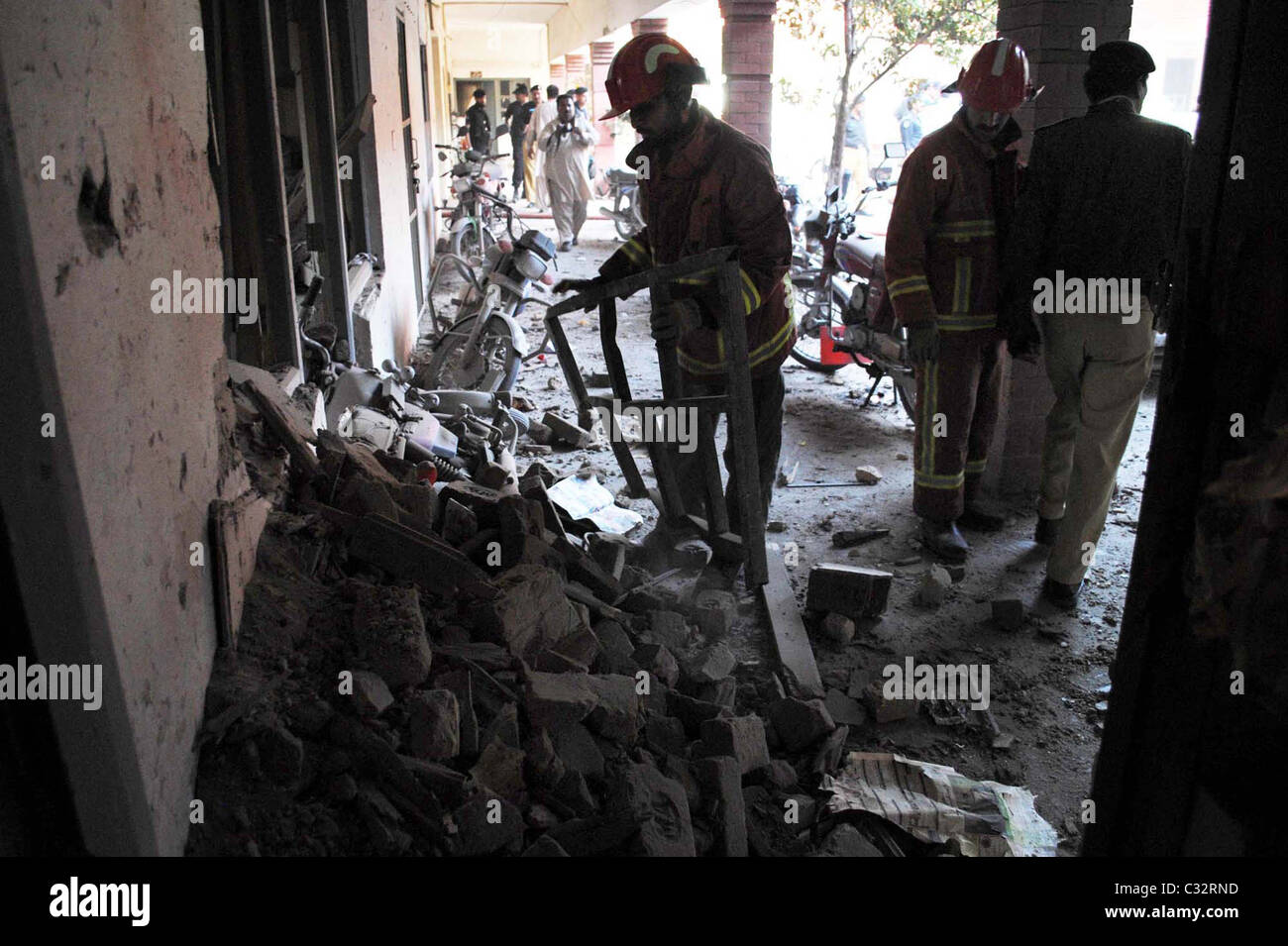 People gather at a damaged portion of building at the site of explosion ...