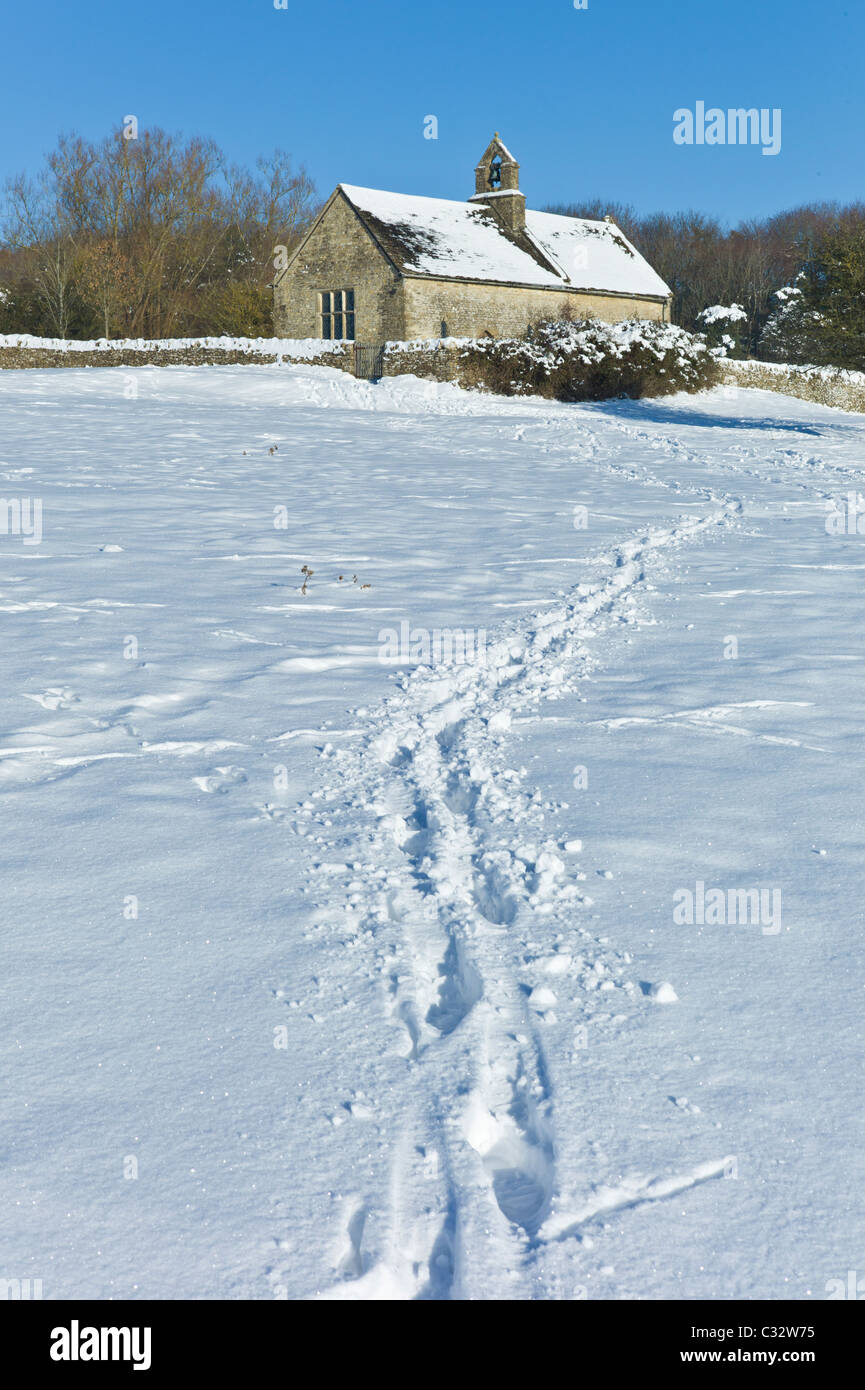 Quaint 13th Century chapel in snow-covered Windrush valley at Widford ...