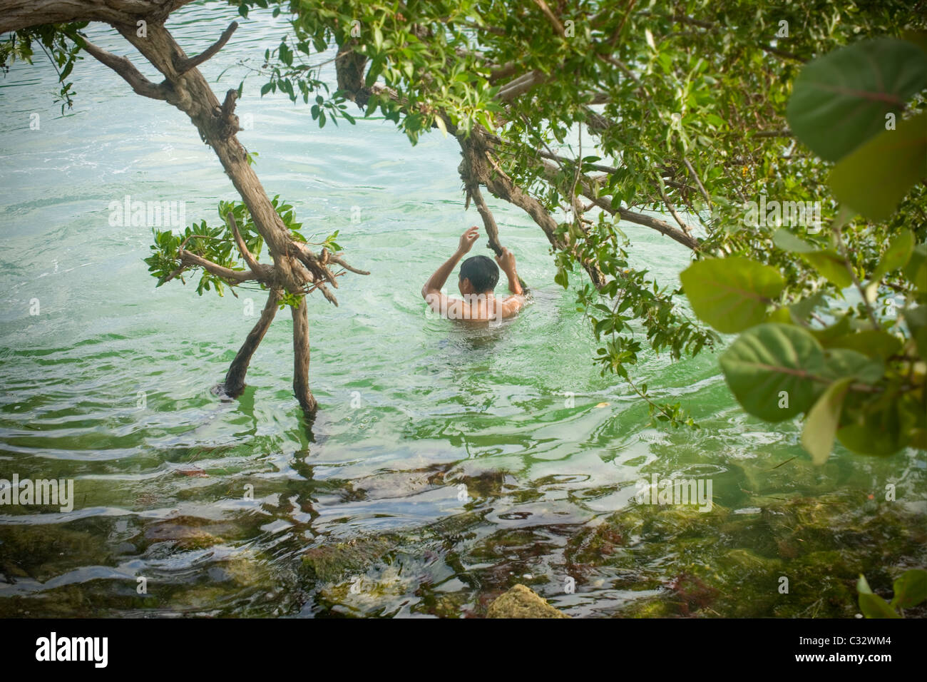 Native Boy swimming in lake Stock Photo - Alamy