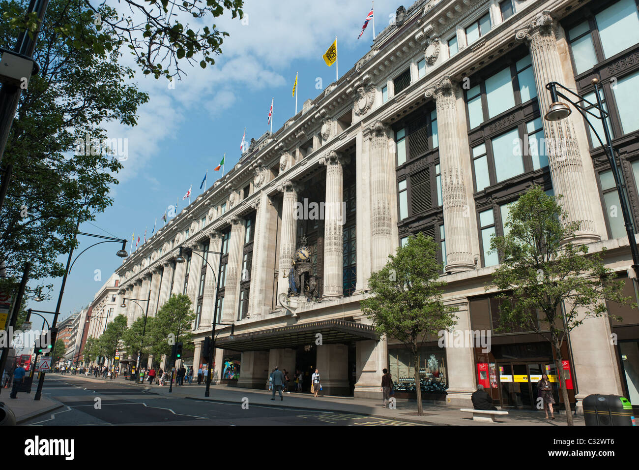Shoppers walk down Oxford Street, past the Queen of Time sculpture ...