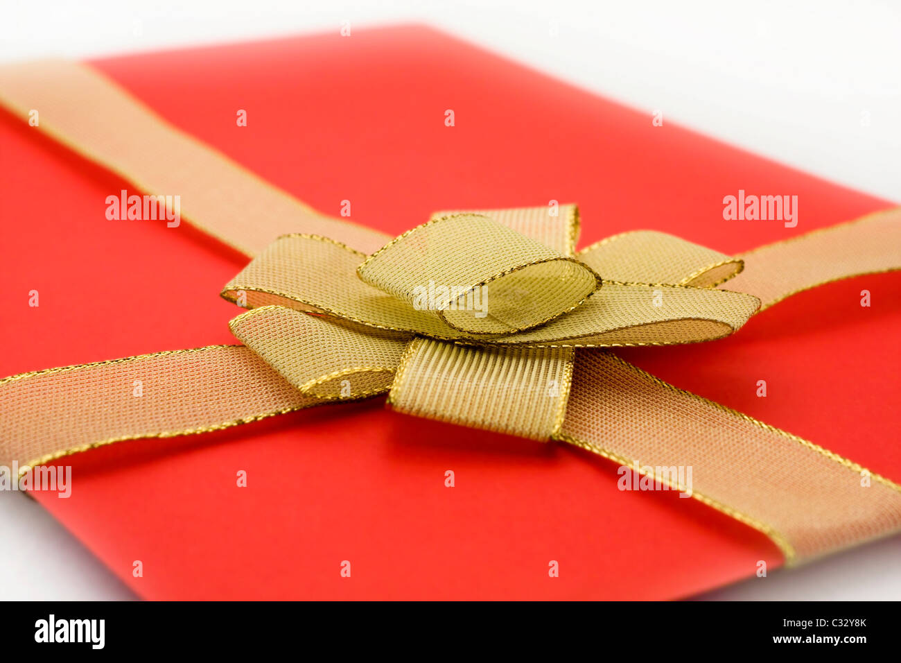 Red box with golden bow and ribbon Stock Photo - Alamy