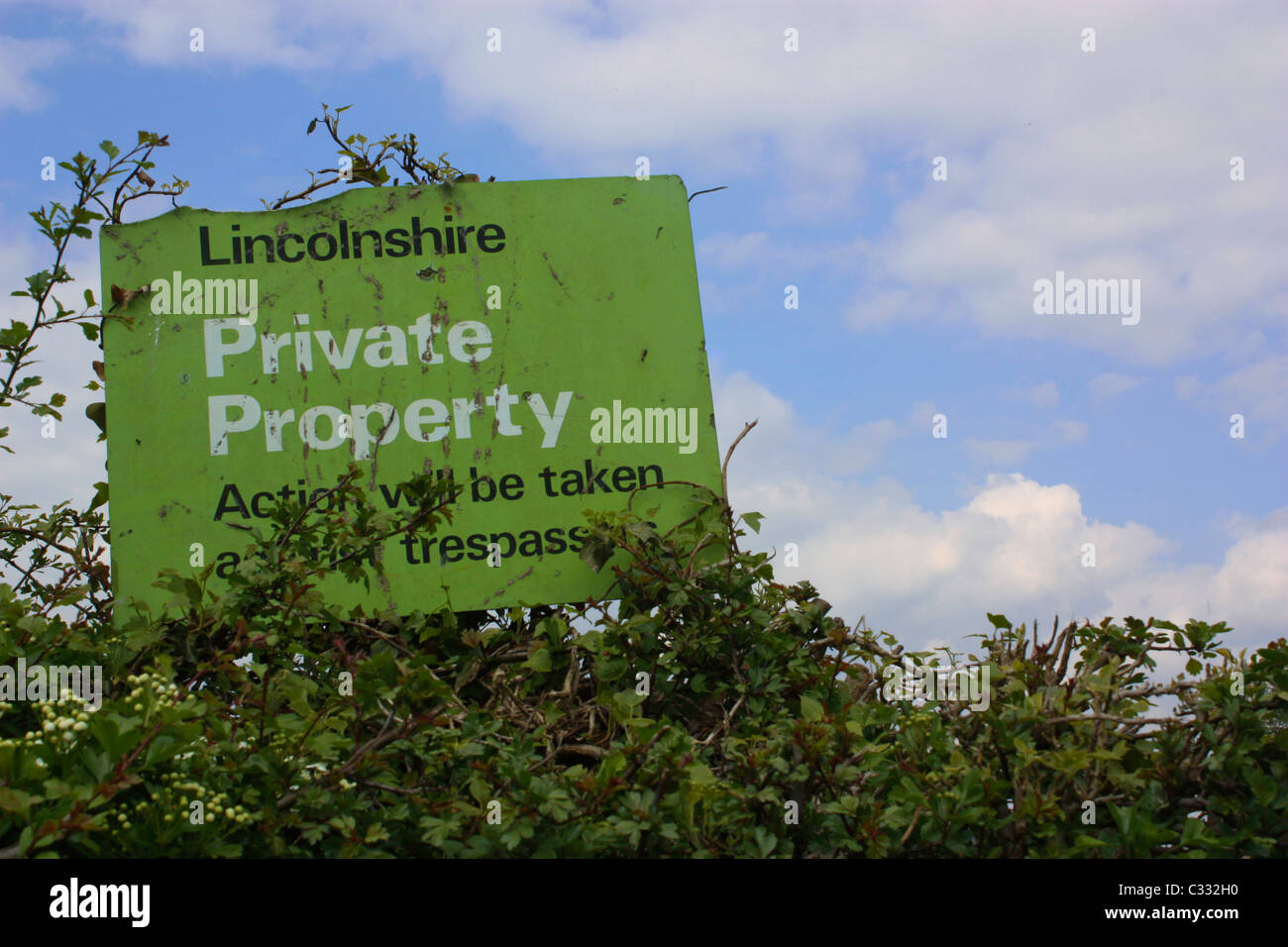 Private Property sign over grown by a piece of shrubbery Stock Photo ...