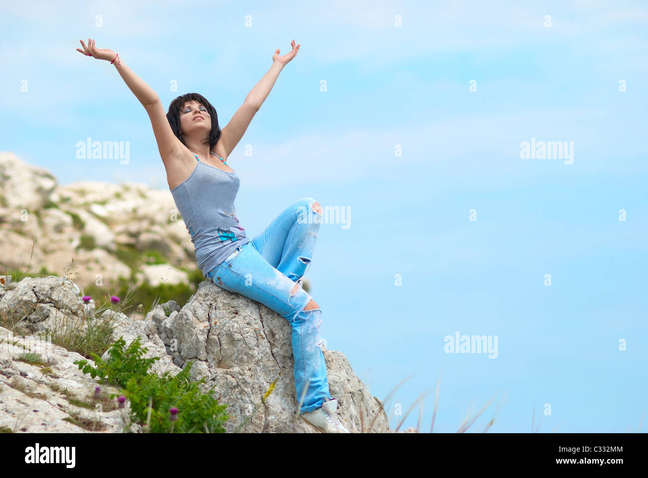 Young woman on the rock Stock Photo - Alamy