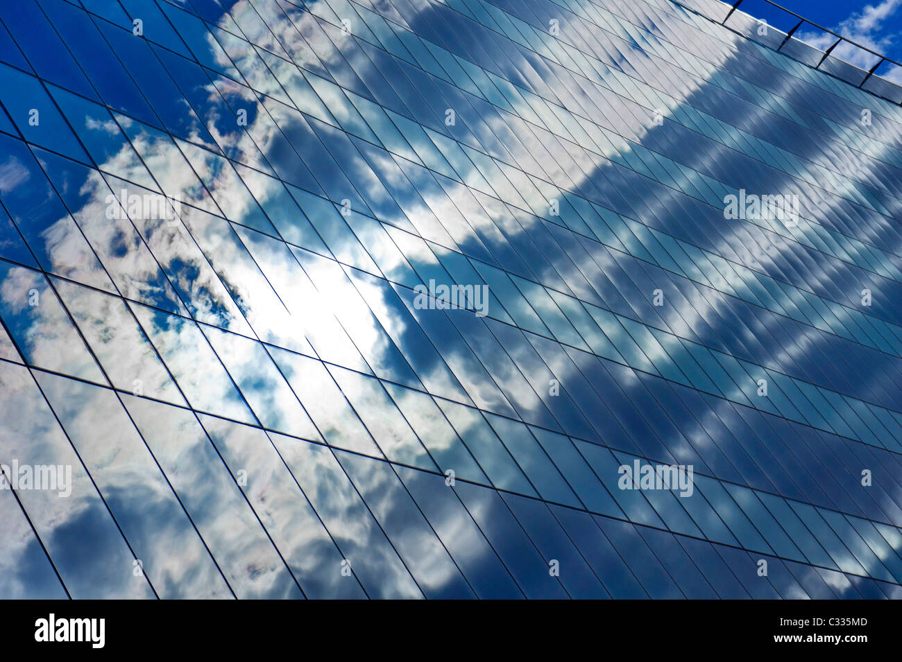 The sun and sky reflected in the windows of a glass skyscraper Stock ...