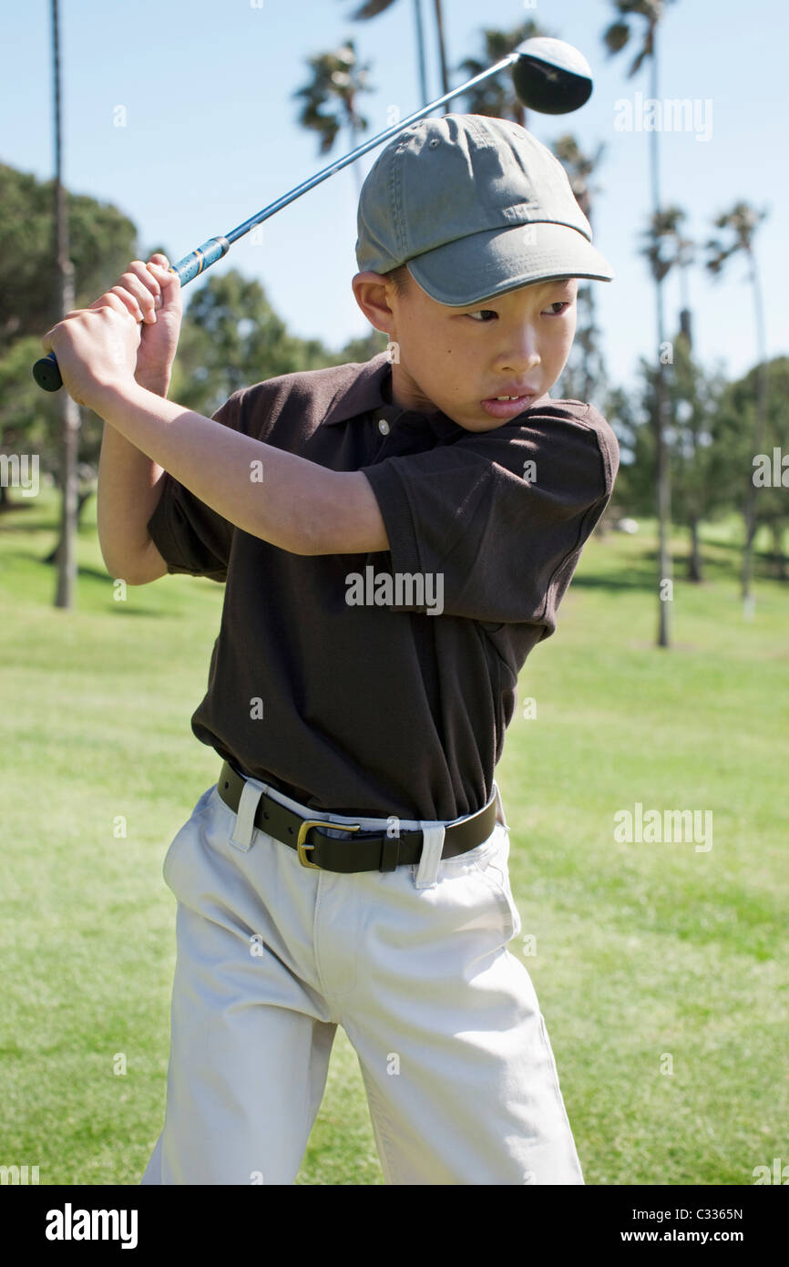 A young boy golfing at a golf course in Los Angeles, California Stock ...