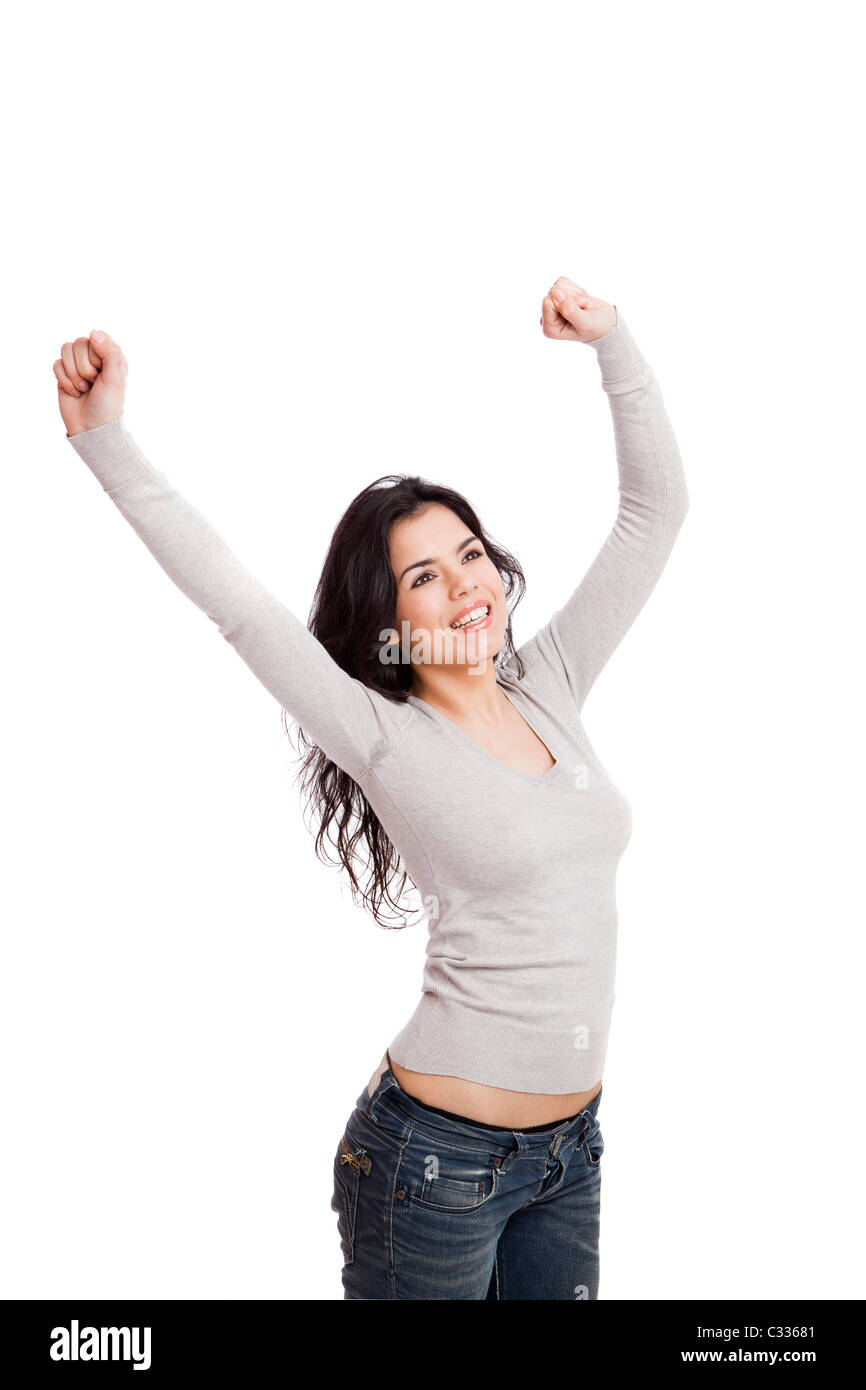 Happy young woman with arms up, isolated against a white background ...