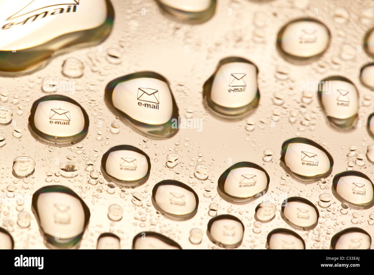 Envelope symbol reflected in the drops of water. Close-up of water ...