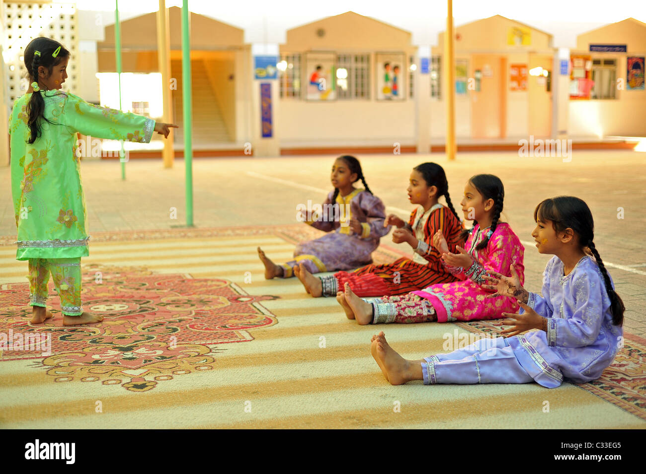 Oman, Muscat, view of female kids singing Stock Photo - Alamy