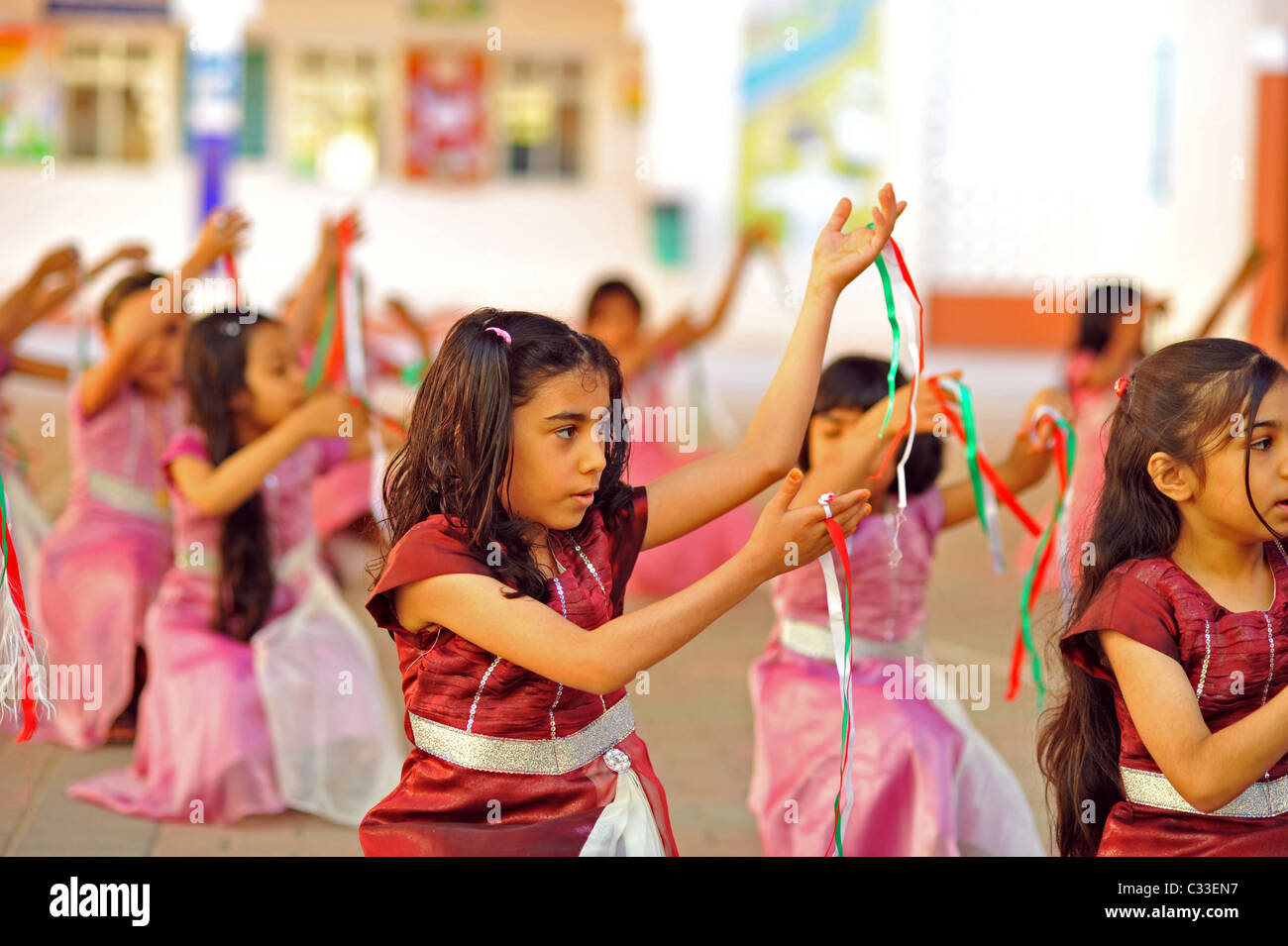 Oman, Muscat, view of kids holding ribbons and dancing Stock Photo - Alamy
