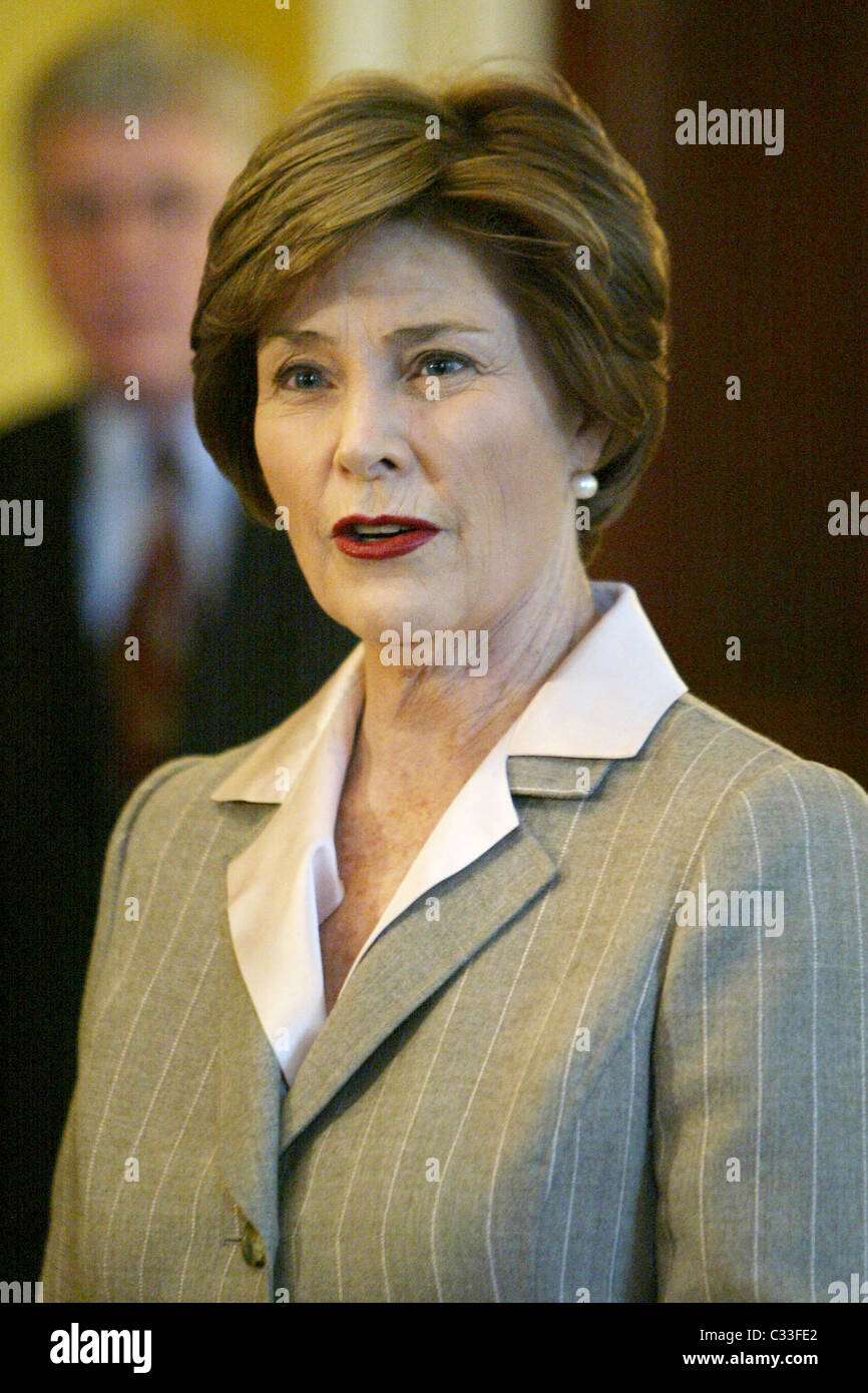 First lady Laura Bush unveils the new gold-rimmed set of official ...