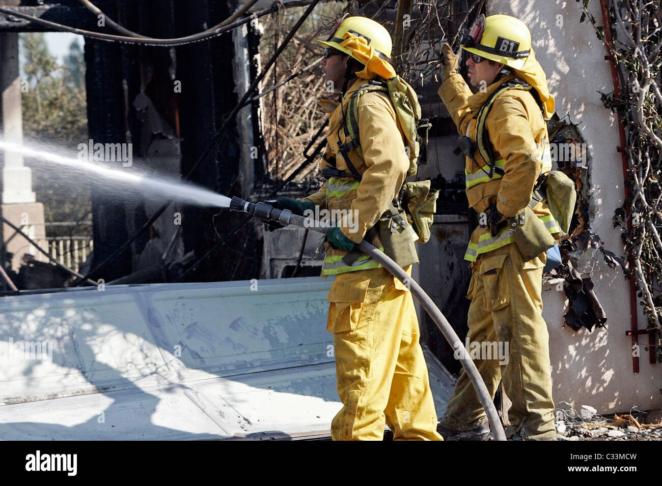 Firefighters Jamie Castaneda and Brian Wilson from LAFD Sta. 61 help ...