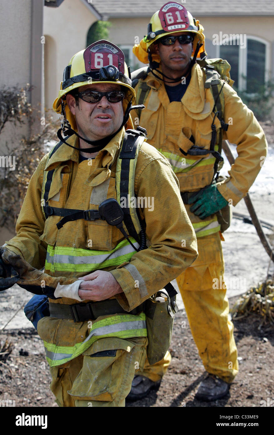 Firefighters Jamie Castaneda and Brian Wilson from LAFD Sta. 61 help ...