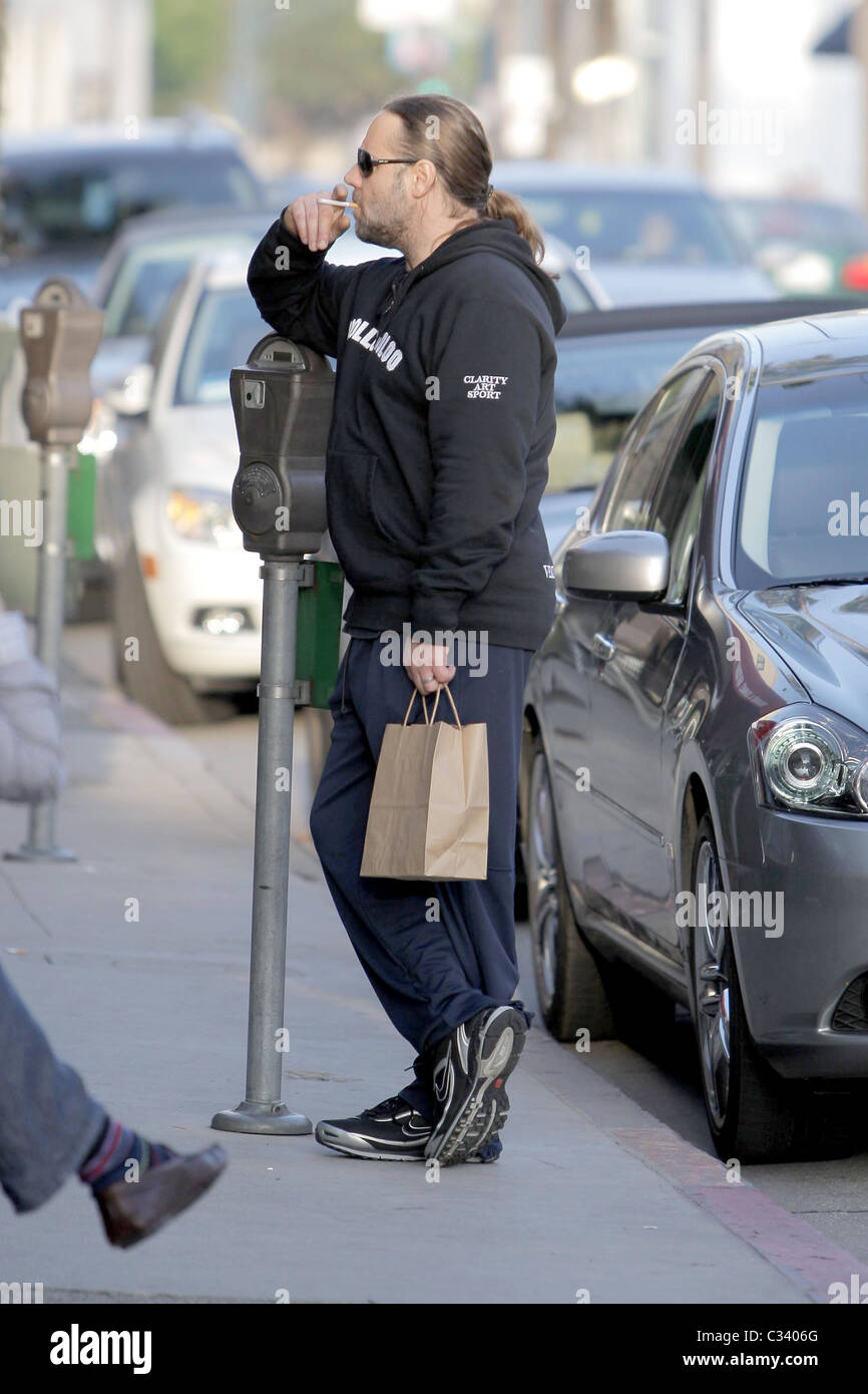 Russell Crowe smokes a cigarette out and about with his wife in Beverly ...