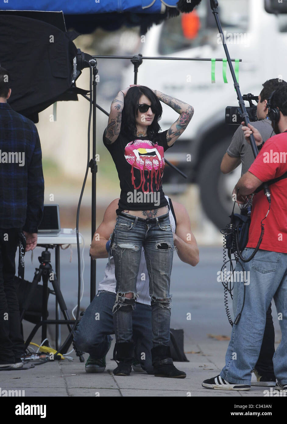 Tattooed mystery woman on the set of a photo shoot for his clothing ...