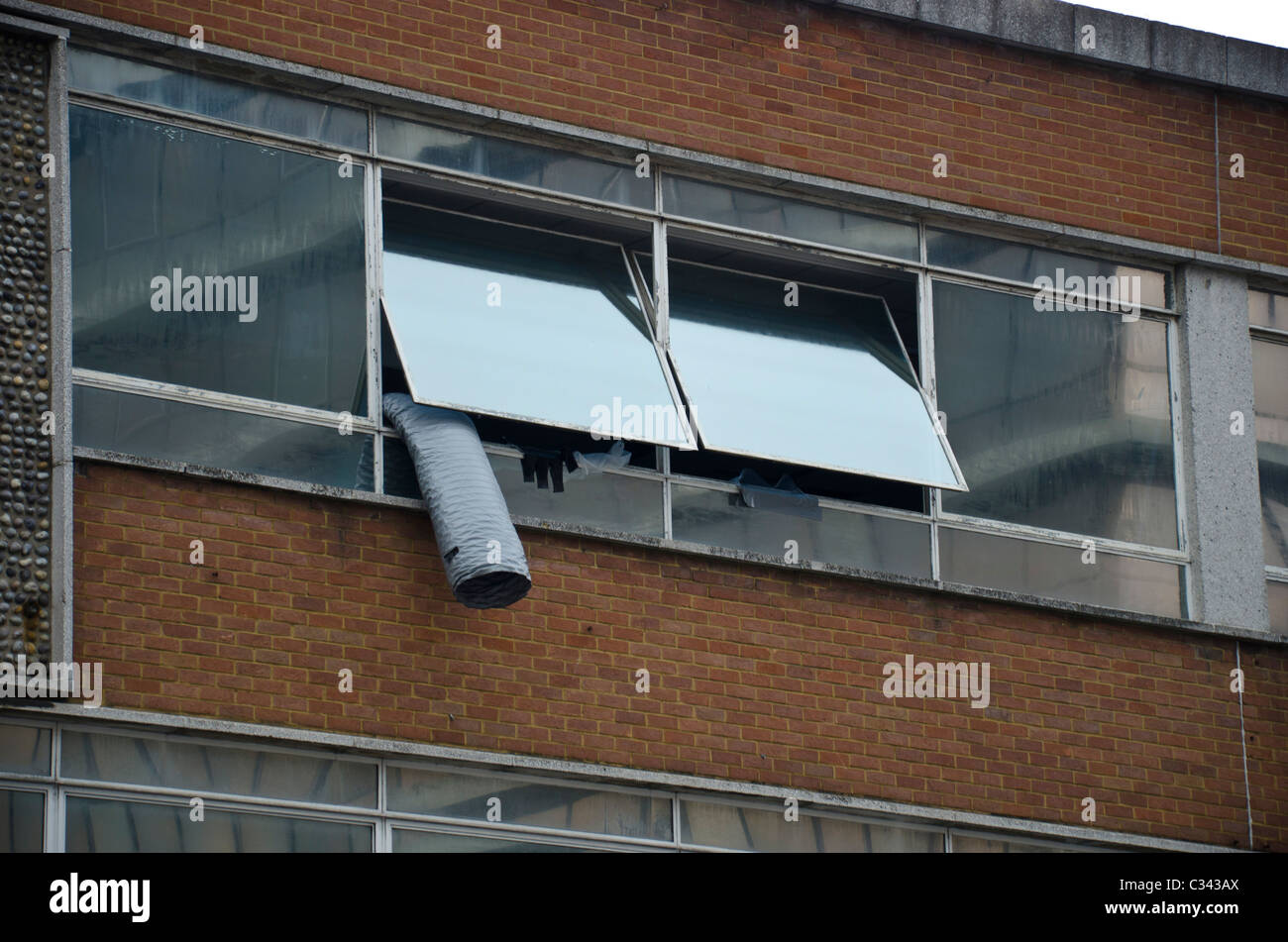 Large flexible pipe hanging out of a window in the centre of Norwich ...