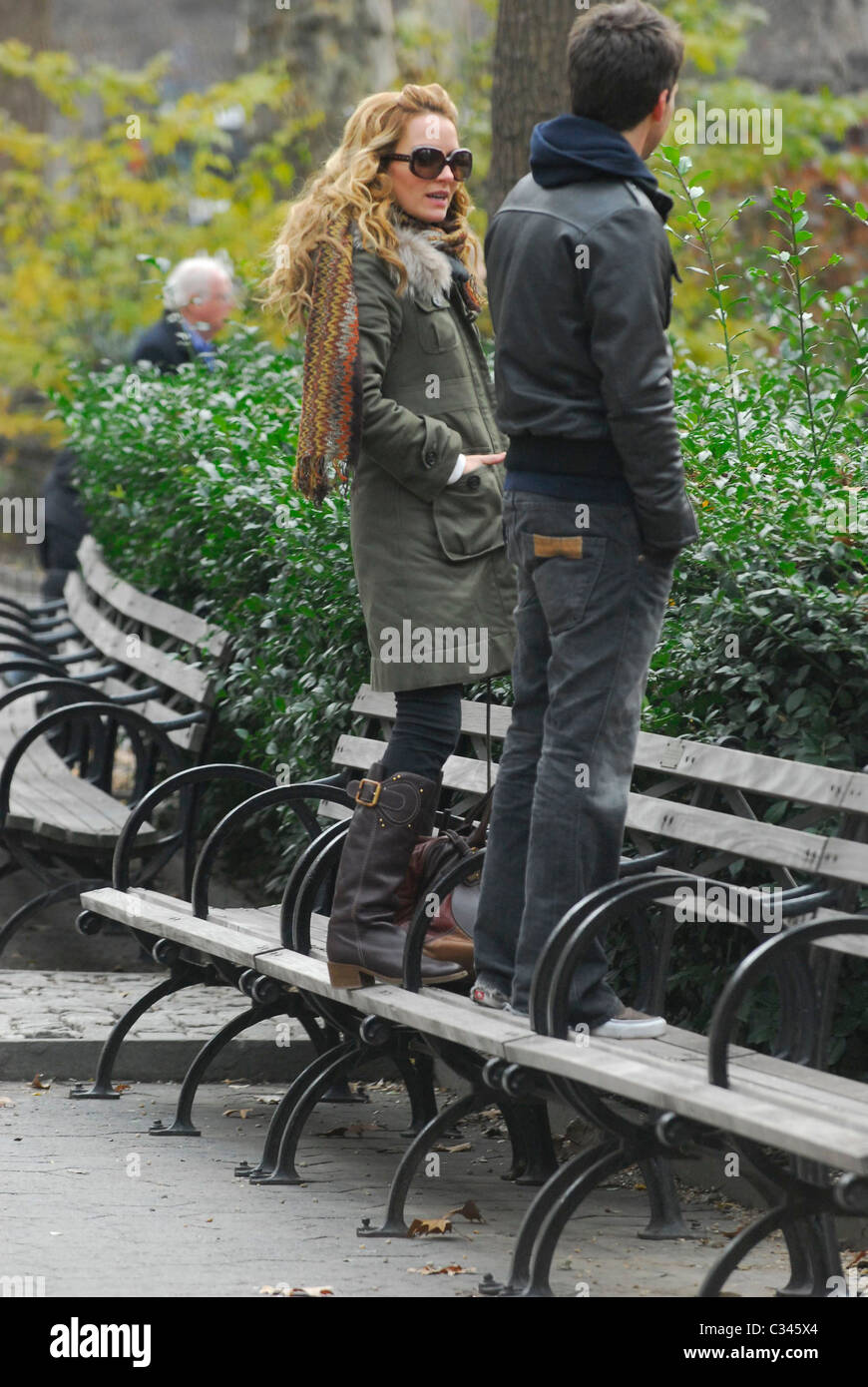 Becki Newton and her brother Matt Newton stand on a park bench to get a ...