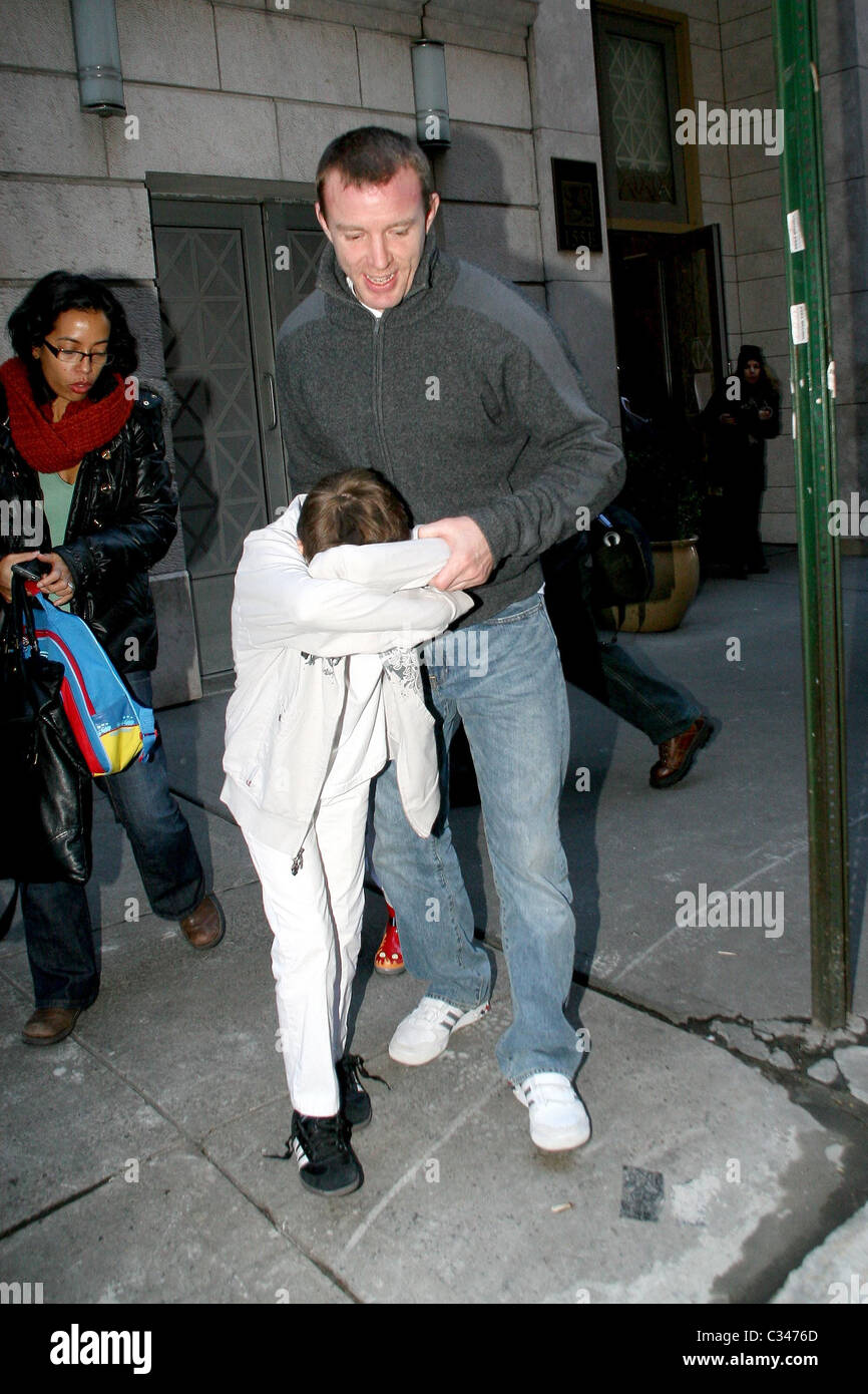 Rocco Ritchie covering his face from photographers and Guy Ritchie Guy ...