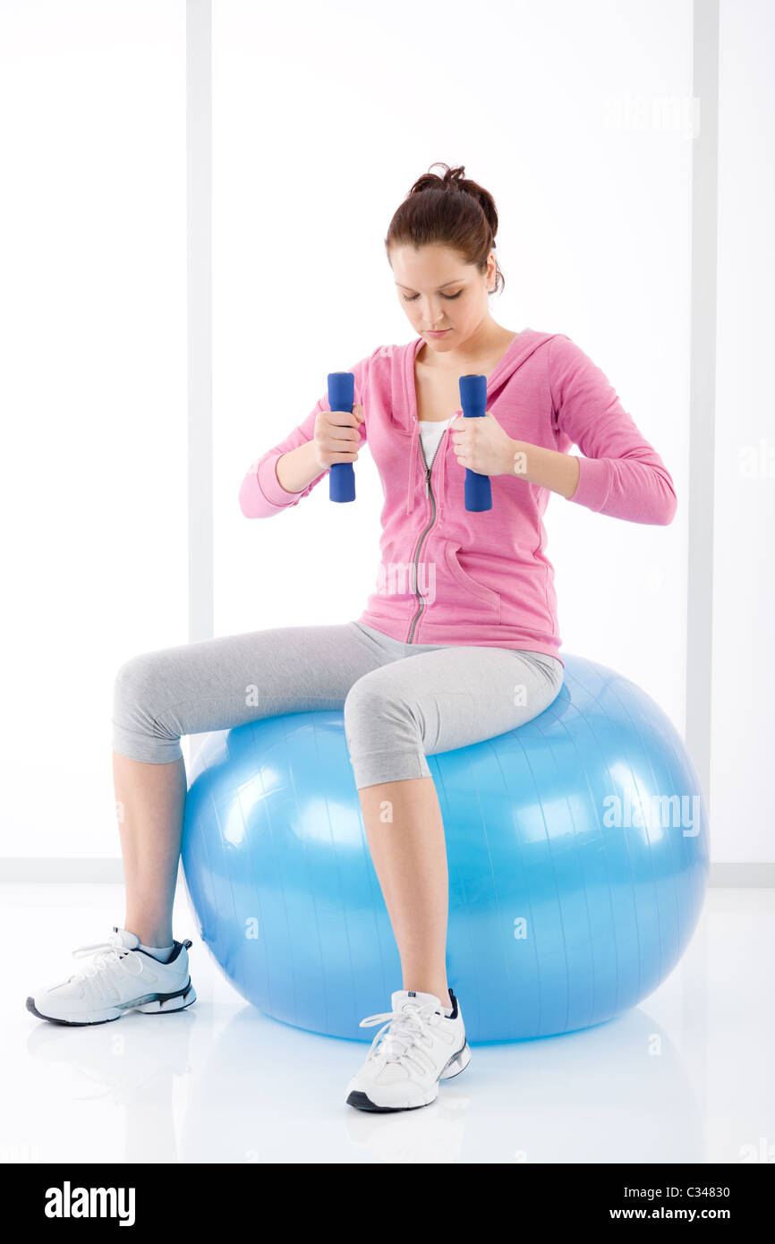 Fitness happy woman exercise dumbbell ball on white Stock Photo - Alamy