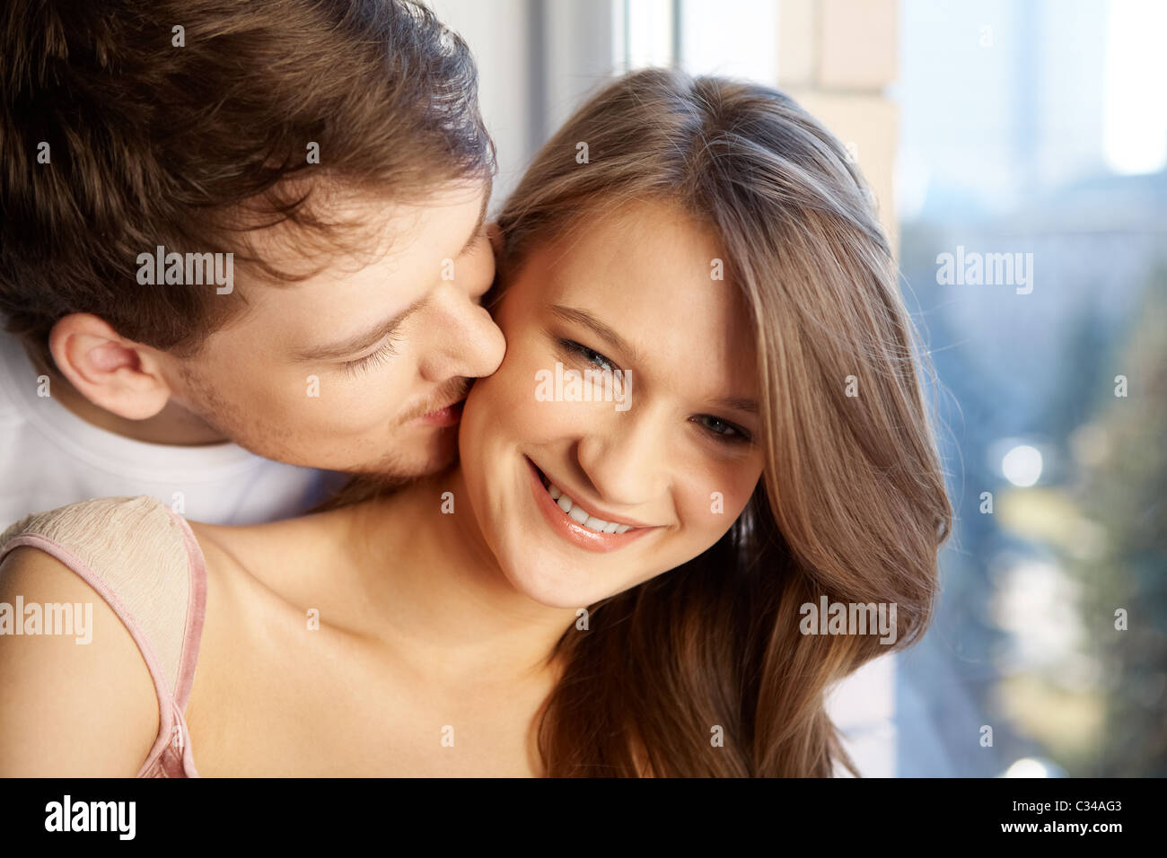 Image of man kissing his girlfriend Stock Photo - Alamy