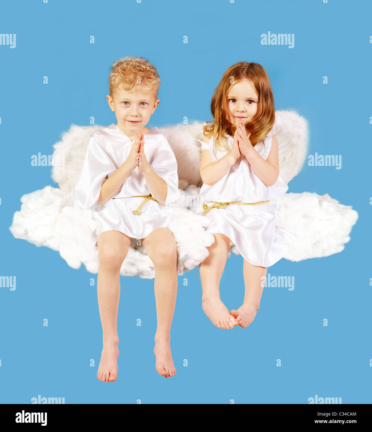 Portrait of two cute angels sitting on the cloud Stock Photo - Alamy
