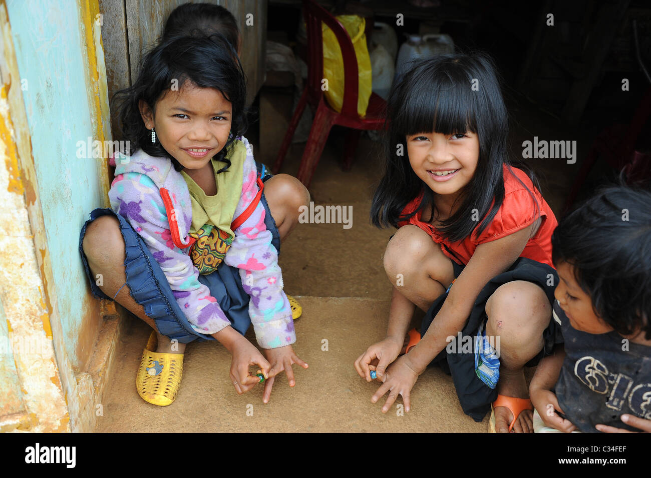 Girls playing with marbles Stock Photo - Alamy