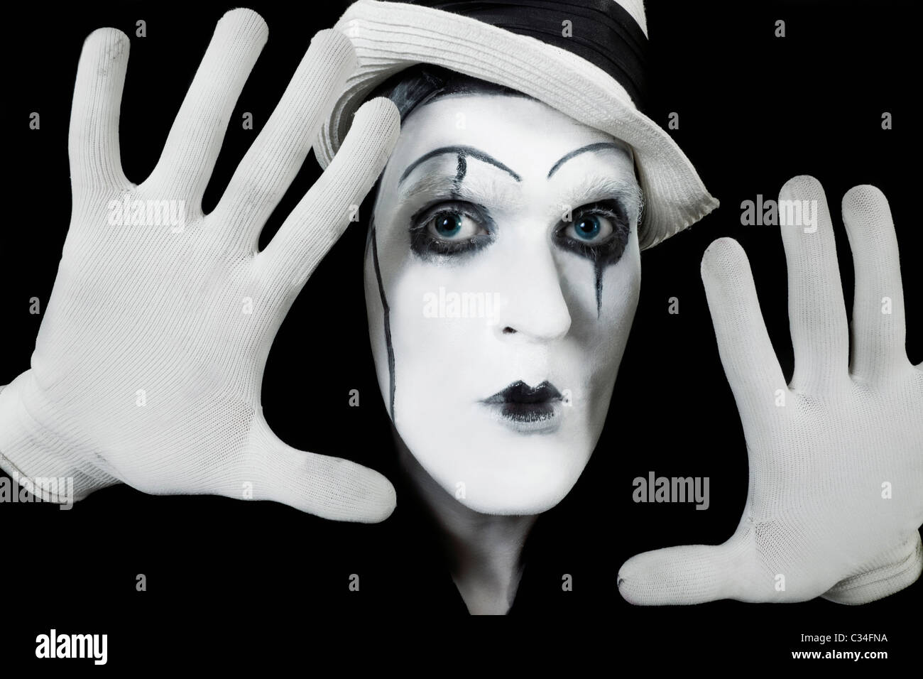 face and hands of mime with dark make-up on black background Stock ...