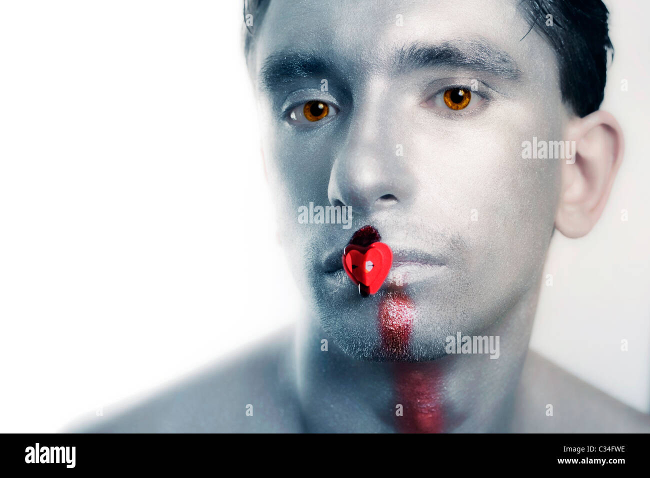 Face of young man with silver makeup and blood closeup Stock Photo - Alamy