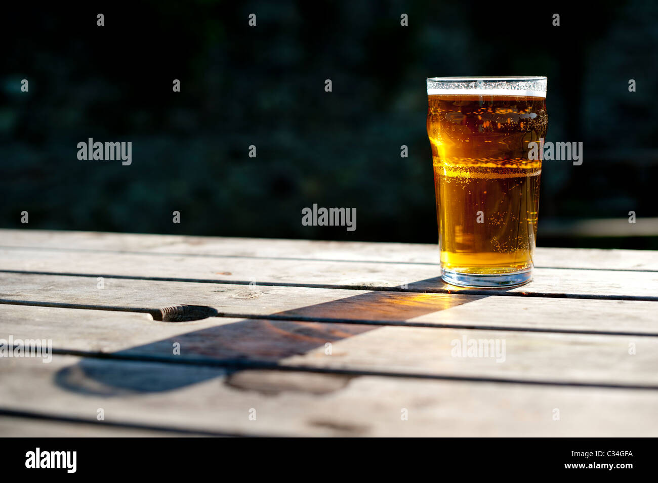 Pint of beer ale on picnic table summer, beer garden Stock Photo - Alamy