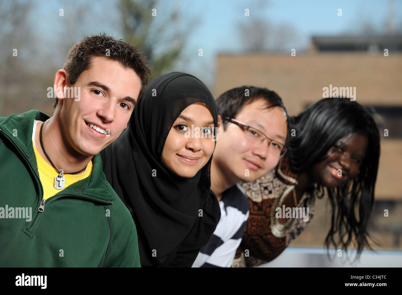 Diverse group of students smiling with selective focus on foreground ...