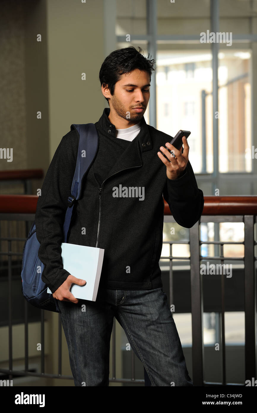 Portrait of young Indian student using cell phone indoors Stock Photo ...