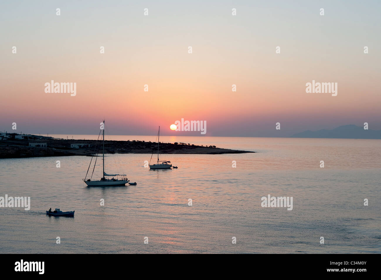 Dawn over the tiny island of Ano Koufonissia, Little Cyclades. At right ...