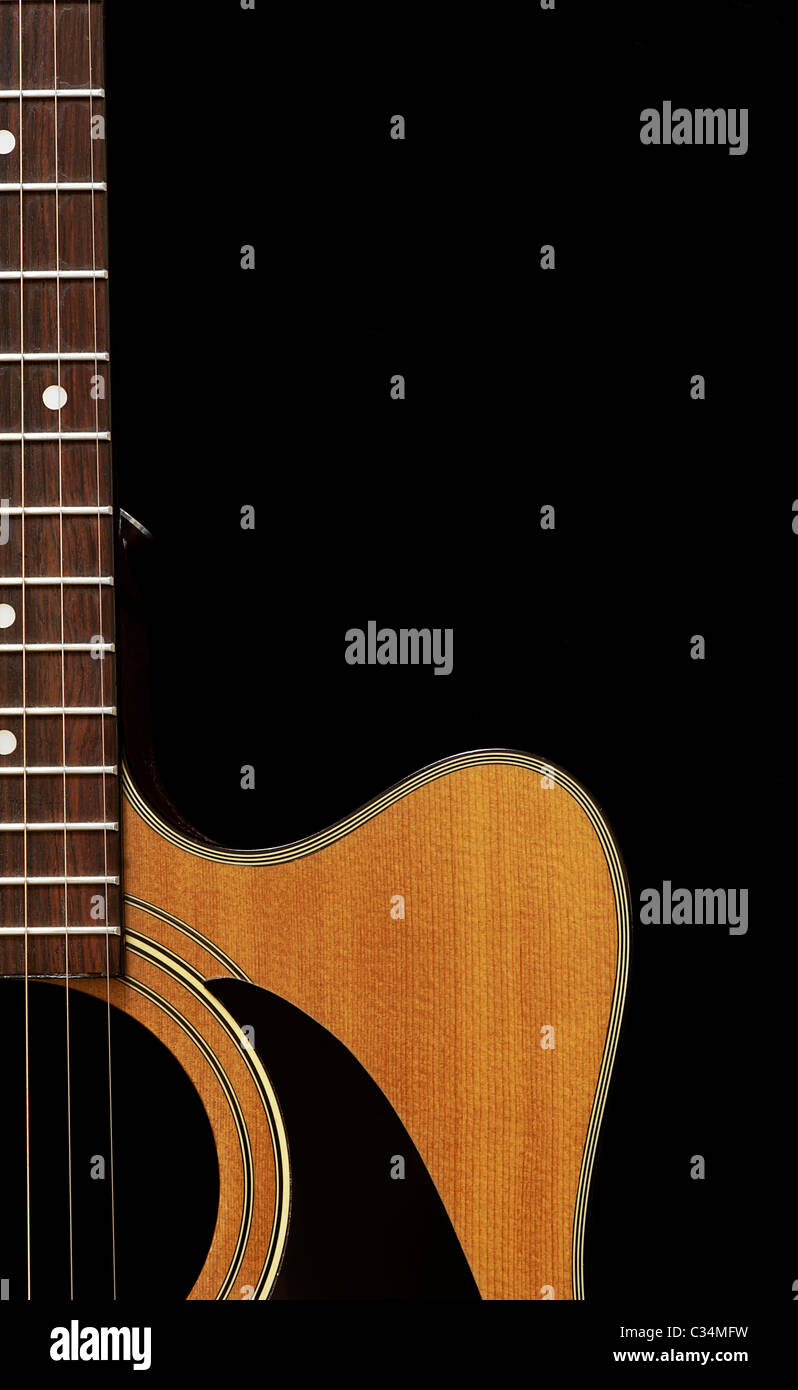 Close up view of a beautiful acoustic guitar isolated on a black ...