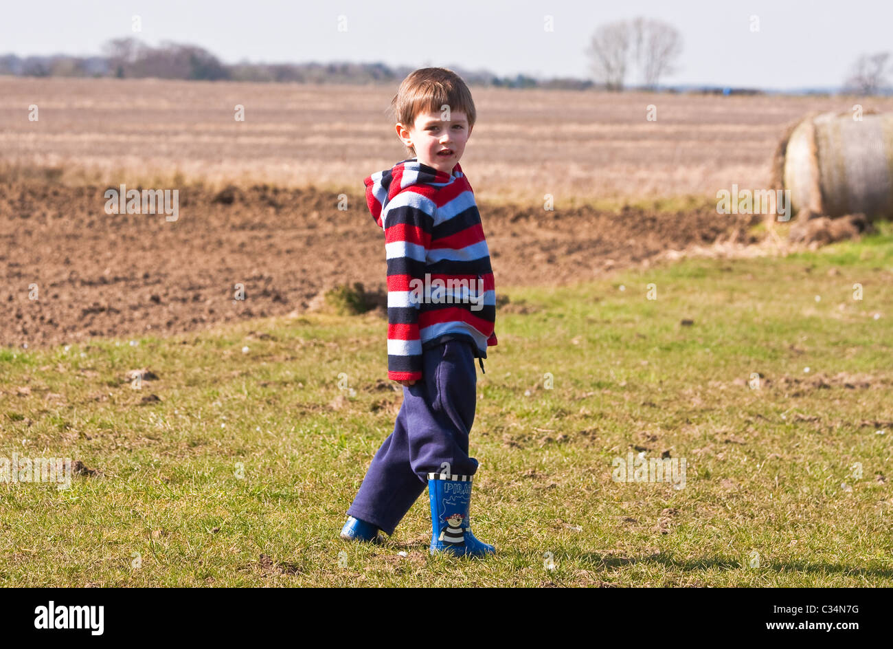 Young boy walking in the countryside Stock Photo - Alamy